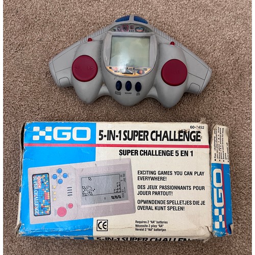 A Go 5-in-1 super challenge handheld game console together with a ...