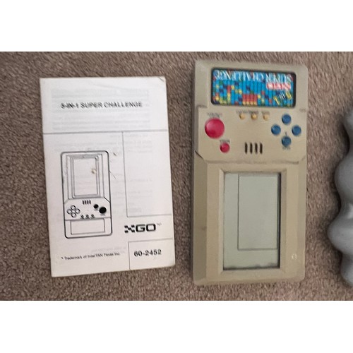 A Go 5-in-1 super challenge handheld game console together with a ...