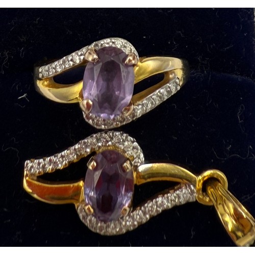 A 9 carat gold ring and matching pendant set with alexandrite and ...