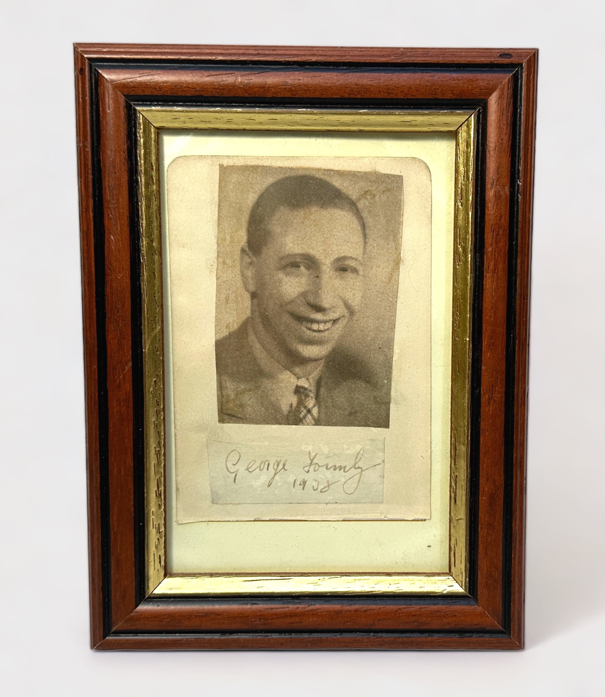 A George Formby signature dated 1958, matted together with a monochrome ...