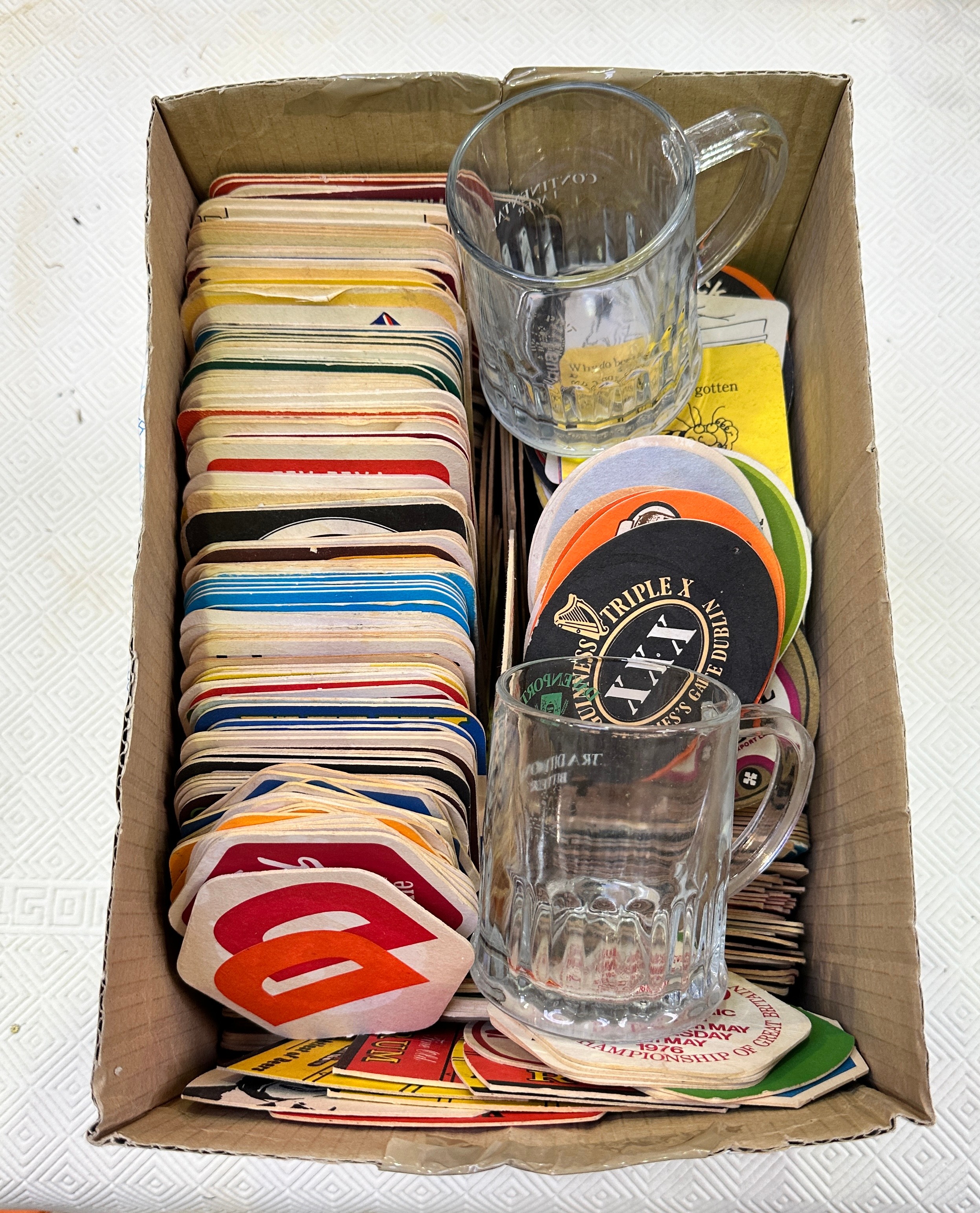 A collection of assorted Yorkshire beer mats and two glass half pint tankards, together with an Ardb