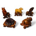 Five various Chinese carved and stained boxwood netsuke on carved ...
