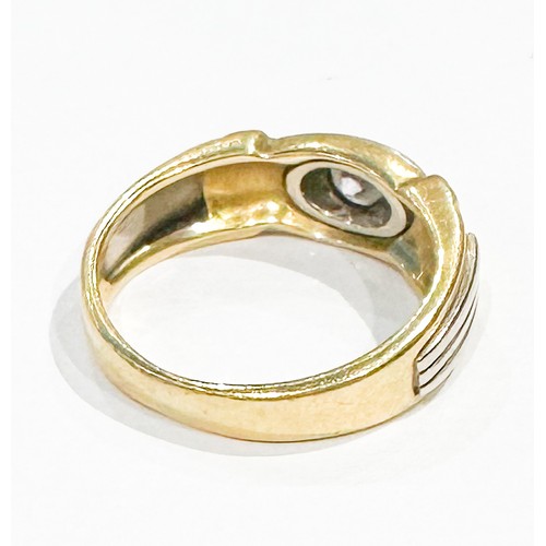 An 18ct yellow and white gold dress ring, rub-over set to the centre ...