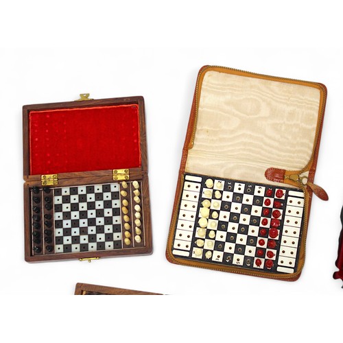 Four assorted travel chess sets, each with fitted cases and boxes ...
