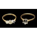 An 18ct gold three-stone ring, centrally set with a rbc diamond and ...