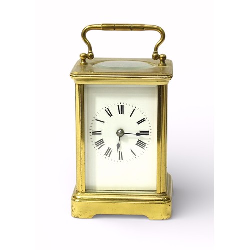 A French brass carriage clock, the white enamel dial with Roman ...