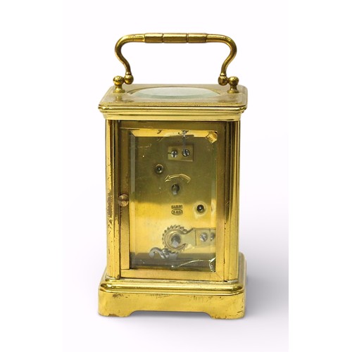 A French brass carriage clock, the white enamel dial with Roman ...
