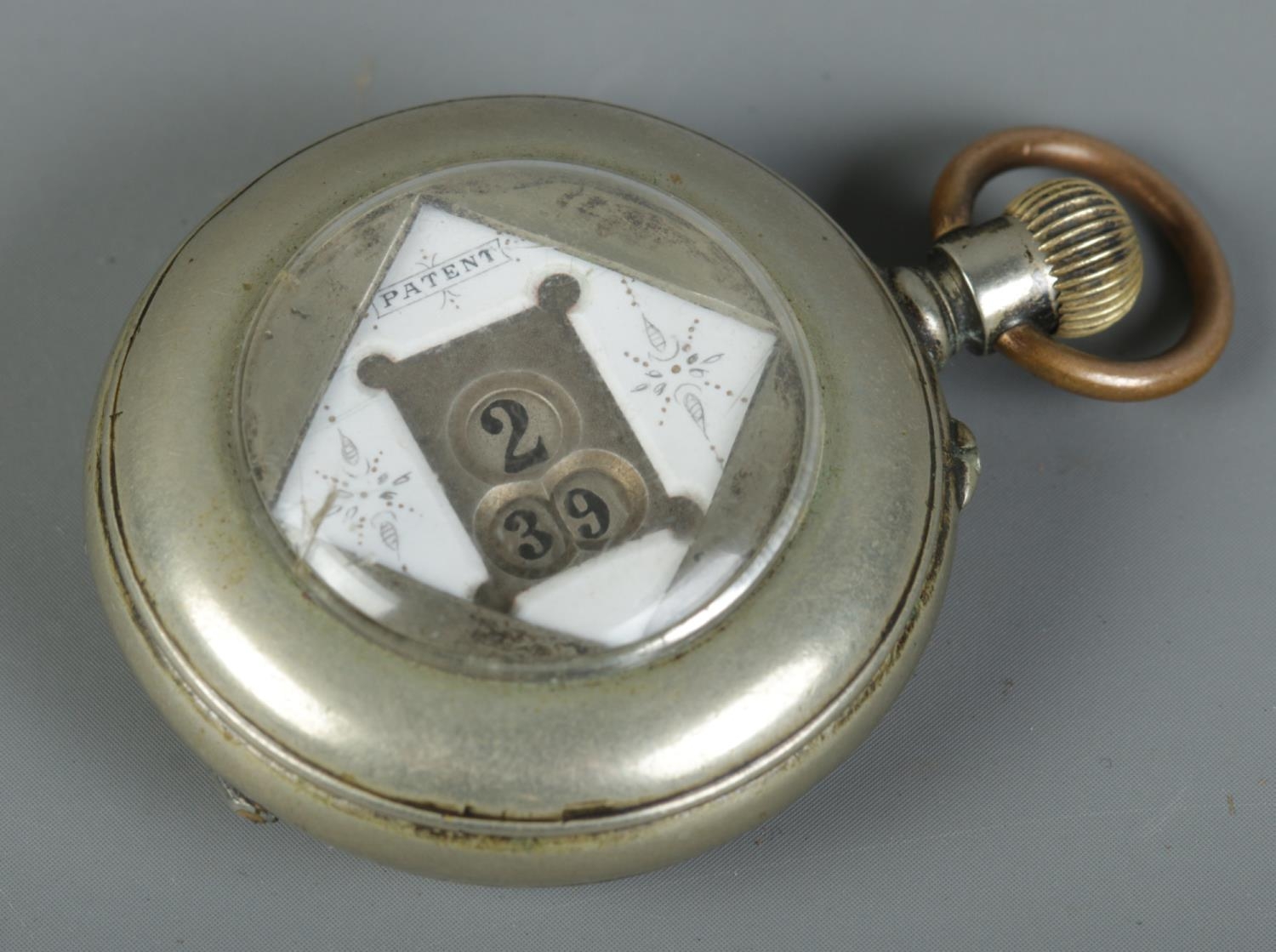 A vintage white metal and enamel jump hour pocket watch.