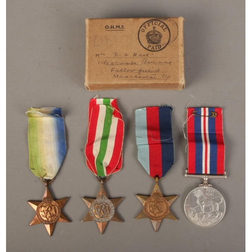A set of four WWII medals with ribbons in box awarded to D.G Hall ...