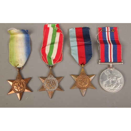 A set of four WWII medals with ribbons in box awarded to D.G Hall ...