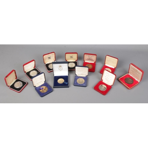 Eleven cased commemorative coins and tokens, to include fiftieth ...