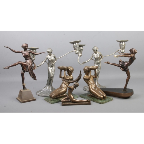 A collection of composite figures including Art Deco candle holders etc.