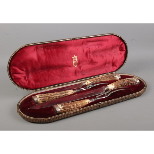 A cased four piece Wade Wingfield and Rowbotham carving set, with horn ...