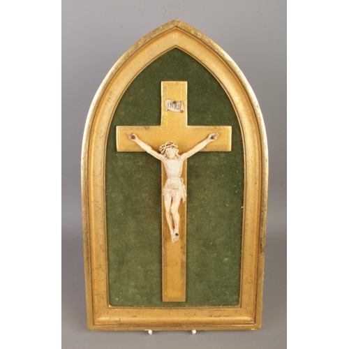 A French gilt framed crucifix with figure of Jesus surmounted with ...