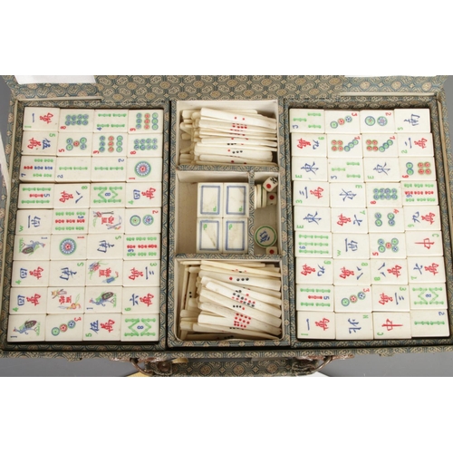 A complete Mahjong set with counters, dice and instruction booklet.