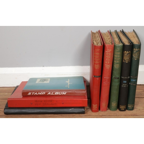 A large box of vintage stamp albums, postcards and photos, including ...