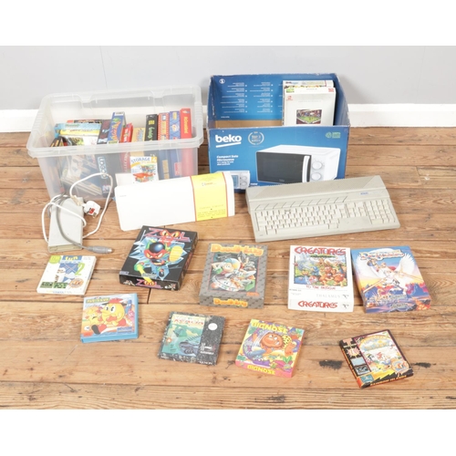 An Atari 520-ST video games console along with a good quantity of games ...