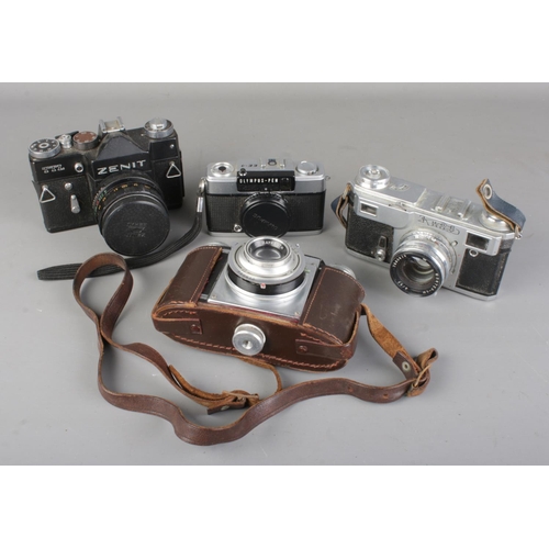 Four vintage cameras. Includes Olympus EE-3, Kiev 4, Zenit TTL and a ...