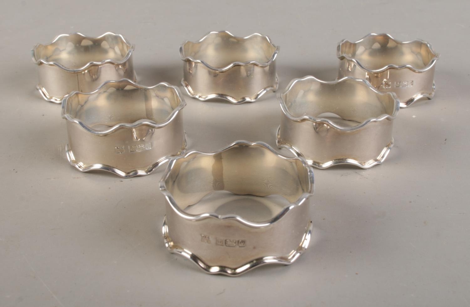 A set of six David Shaw Silverware Ltd. napkin rings in wave form ...