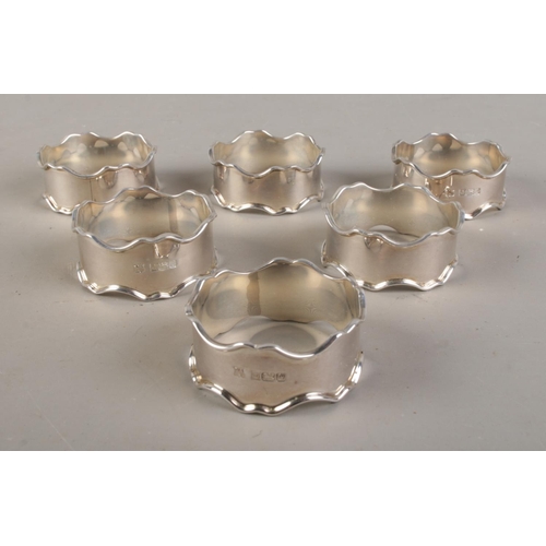 A set of six David Shaw Silverware Ltd. napkin rings in wave form ...