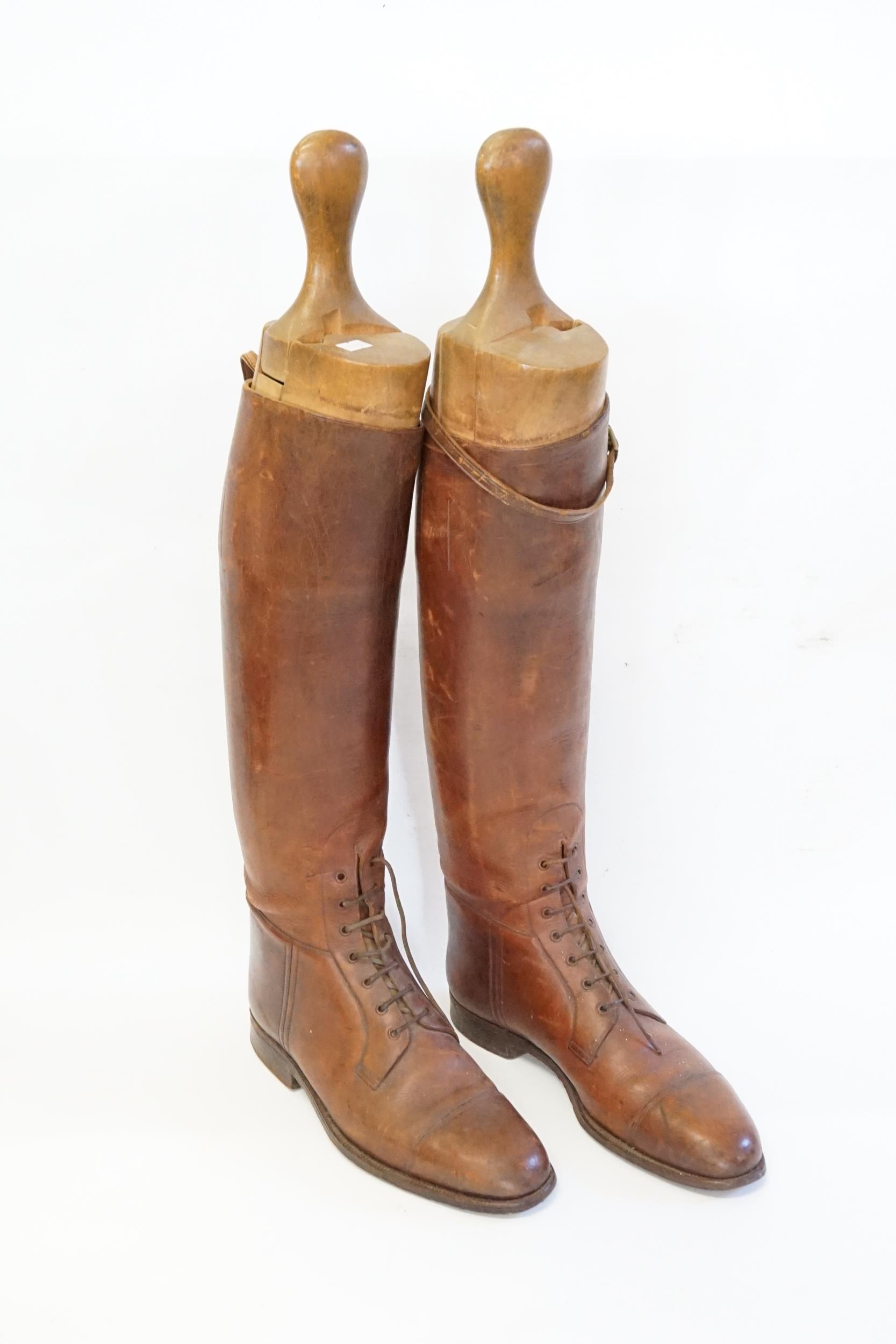 A pair of Gentleman's leather boots with putties and boot jacks.