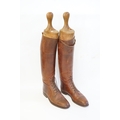 A pair of Gentleman's leather boots with putties and boot jacks.