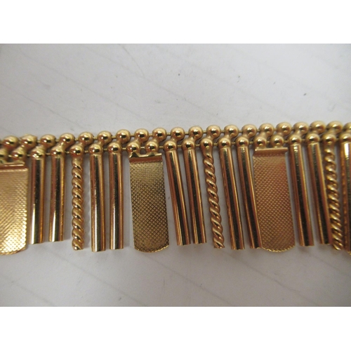 An 18ct gold rod, pendant and tab design necklace, on a bayonet clasp