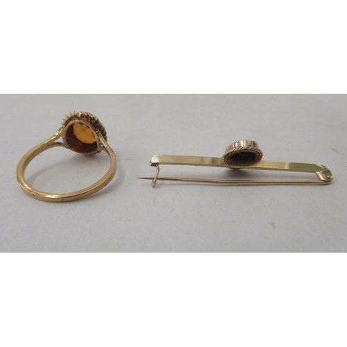 A 9ct gold scarf pin, set with a black opal; and a 9ct gold ring, set ...
