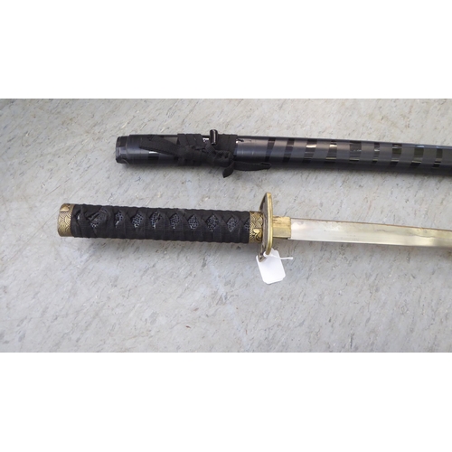 A reproduction of a Japanese Samurai sword with a rope clad handle the ...