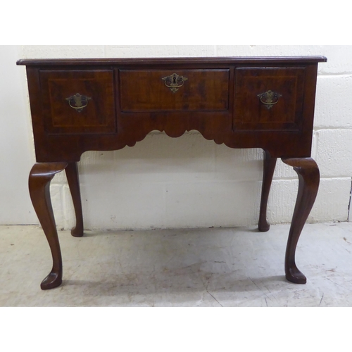 A George III crossbanded walnut and mahogany three drawer lowboy ...