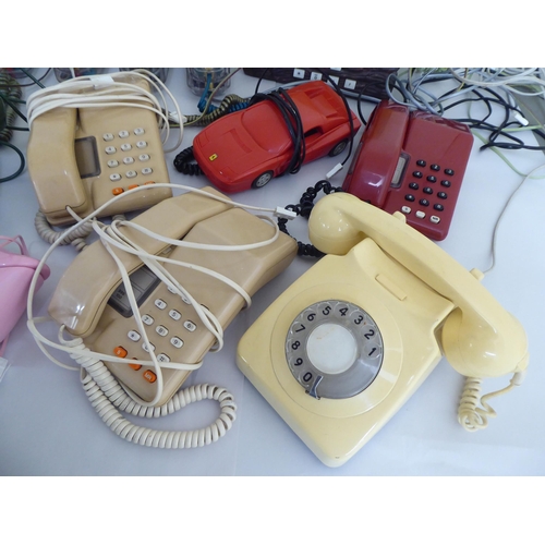 Various landline telephones: to include an example fashioned as a ...