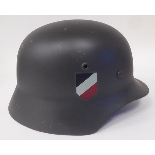 Three various German World War II design, military steel helmets with ...