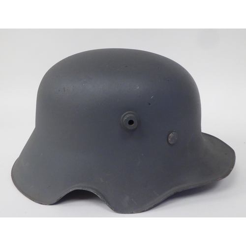 Three various German World War II design, military steel helmets with ...