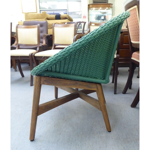 A modern Indonesian made green wicker style easy chair, on a teak ...
