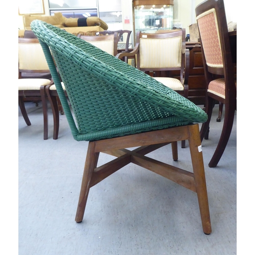 A modern Indonesian made green wicker style easy chair, on a teak ...