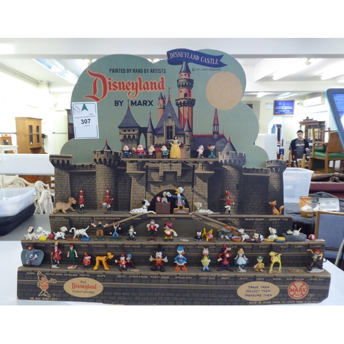 A Disneyland by Marx Toys, a printed card display, comprising a ...