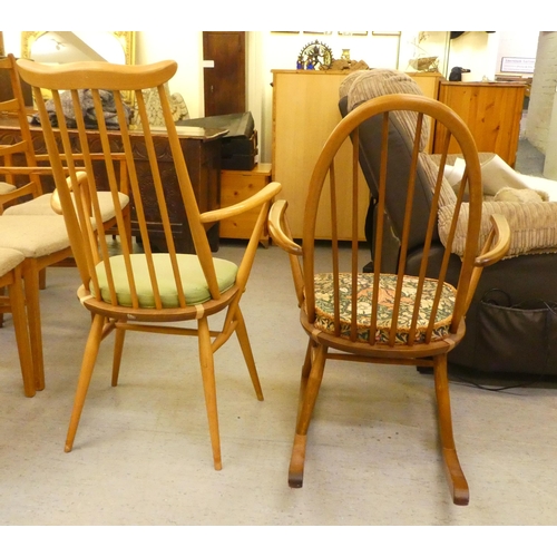 An Ercol honey coloured beech and elm framed, high hoop and spindled ...