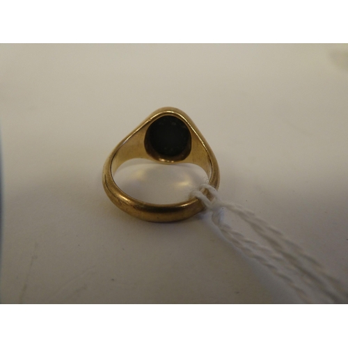 A gentleman's 9ct gold signet ring, set with a carved grey stone tablet