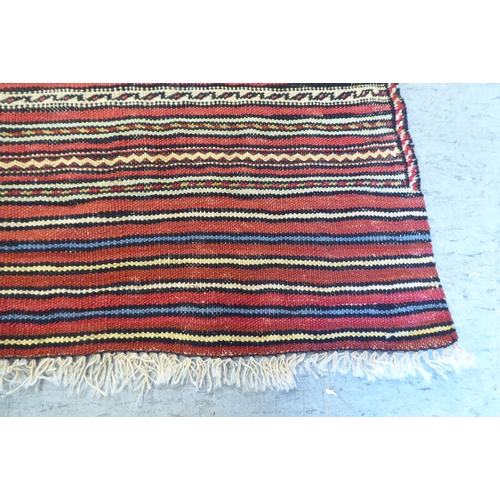 A Kelim rug, on a striped, multi-coloured ground 53" 73"