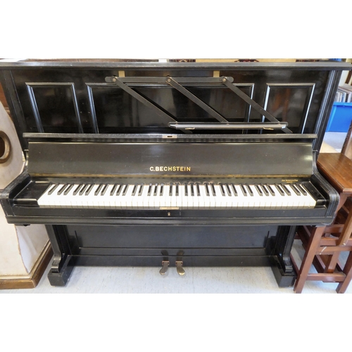 A Bechstein black lacquered cased, upright wooden framed, overstrung ...