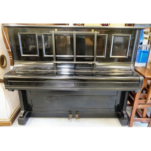 A Bechstein black lacquered cased, upright wooden framed, overstrung ...
