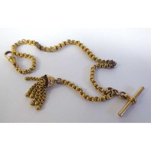 A yellow metal pocket watch chain stamped 10
