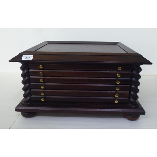 A modern stained, wooden table-top coin collector's cabinet, comprising ...