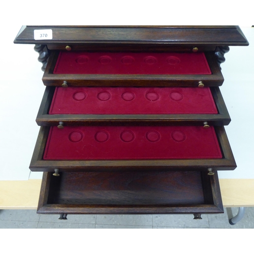 A modern stained, wooden table-top coin collector's cabinet, comprising ...
