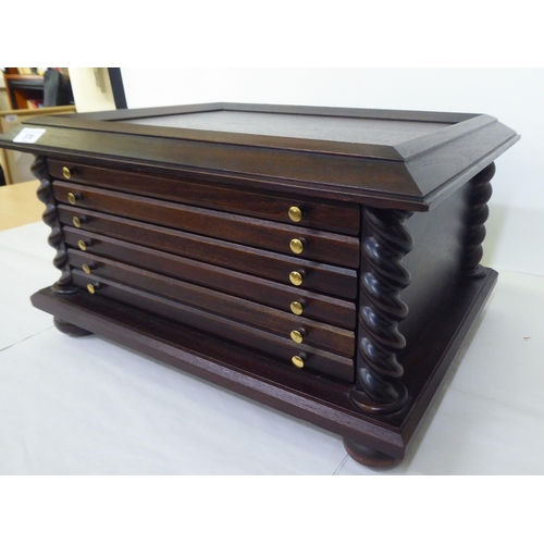A modern stained, wooden table-top coin collector's cabinet, comprising ...