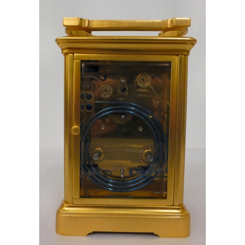 An early/mid 20thC glazed and brass cased carriage clock; faced by a ...