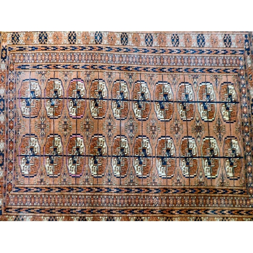 A Persian Bokhara design rug, decorated with two columns of guls ...