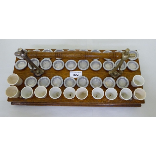 A 1920s oak Holy Communion board with ceramic tot cups and pewter bread ...