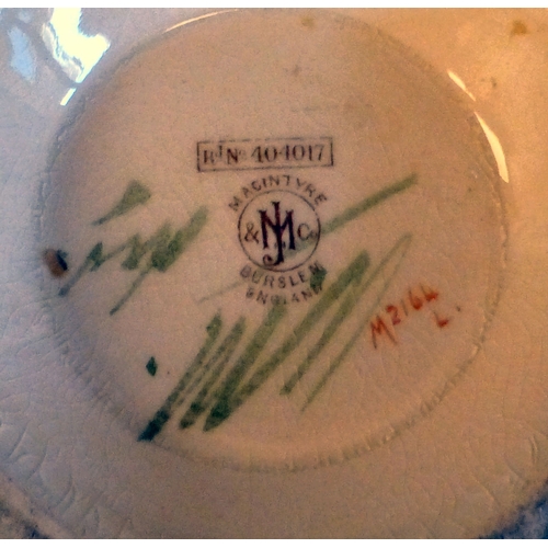 A MacIntyre pottery vase with a narrow neck and flared rim, decorated ...