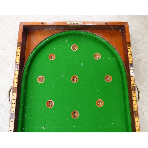 An Edwardian mahogany table-top folding bagatelle board, the baize ...